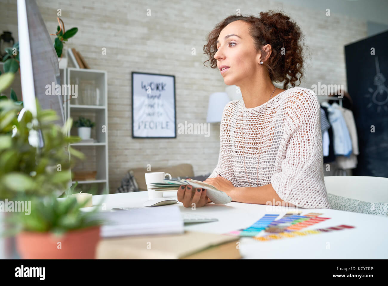 Side view portrait of young woman looking computer screen while working ...