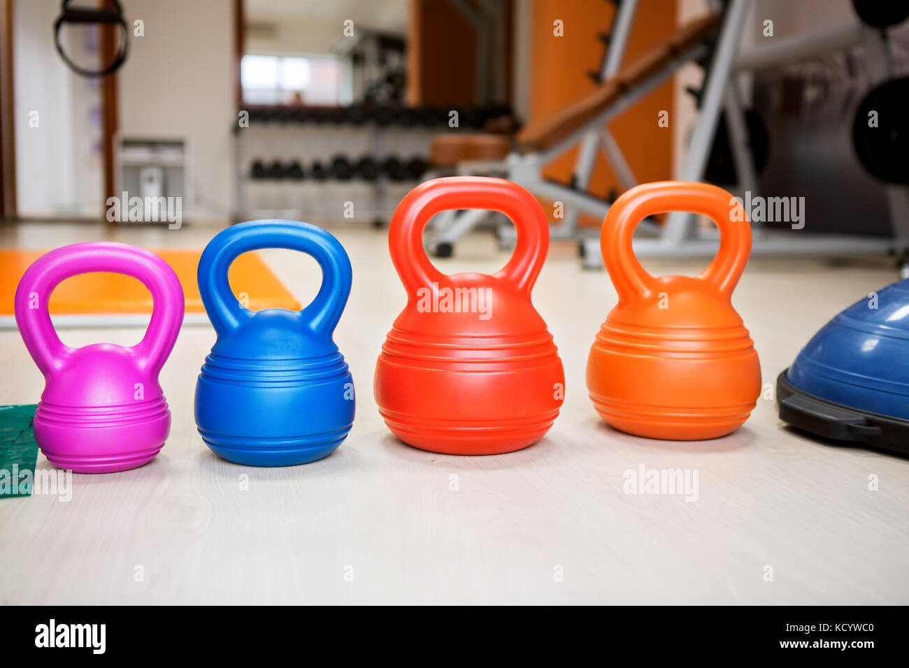 Four different kettle bell Stock Photo - Alamy