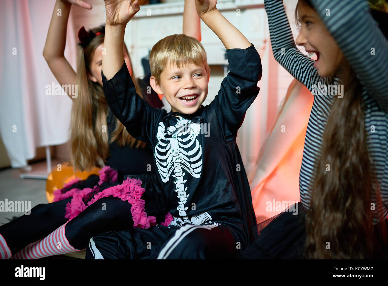 Portrait of smiling little boy wearing skeleton costume having fun ...