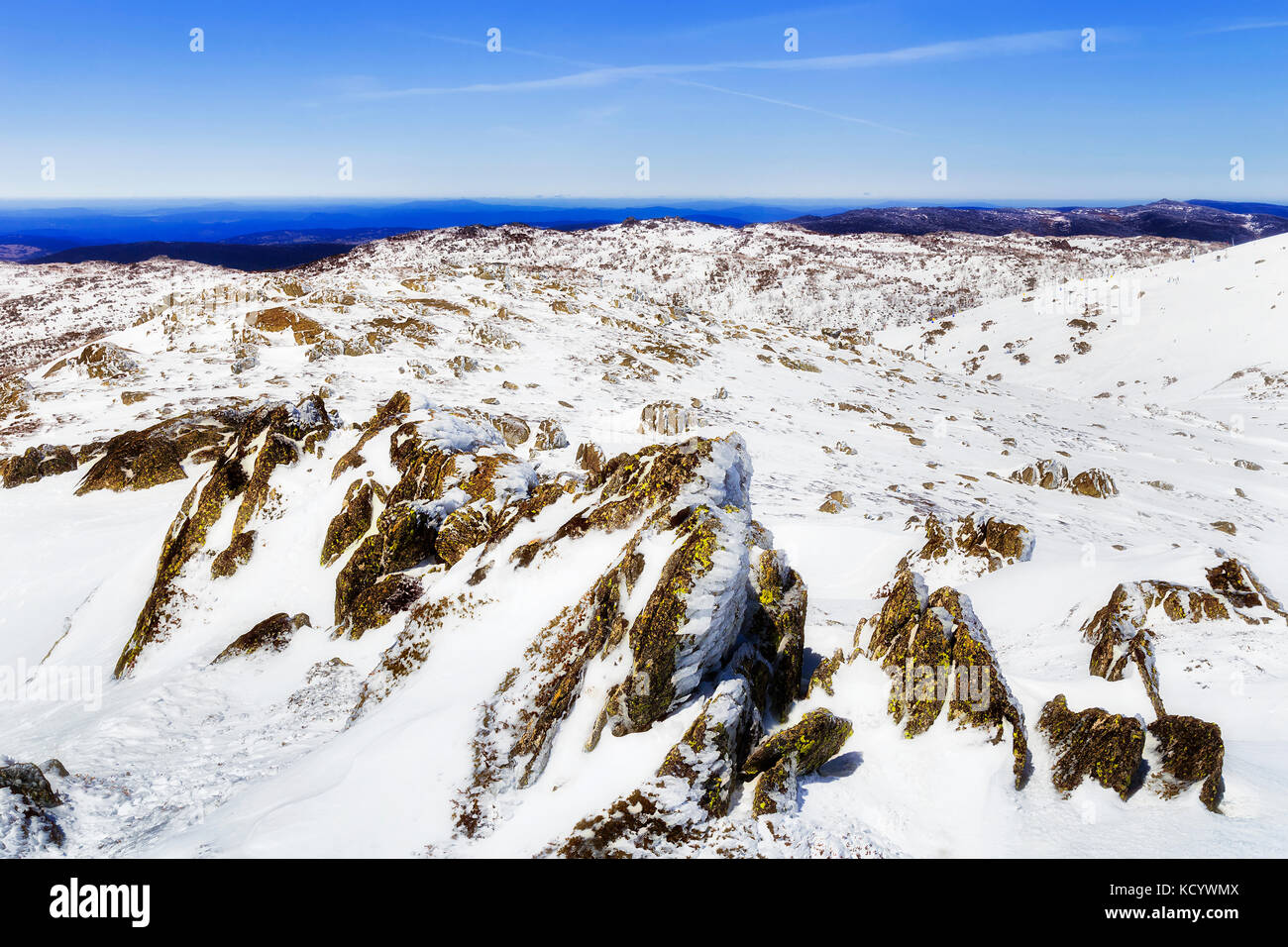 Rocky stones covered by moss and snow on top of Black Perisher mount in ...