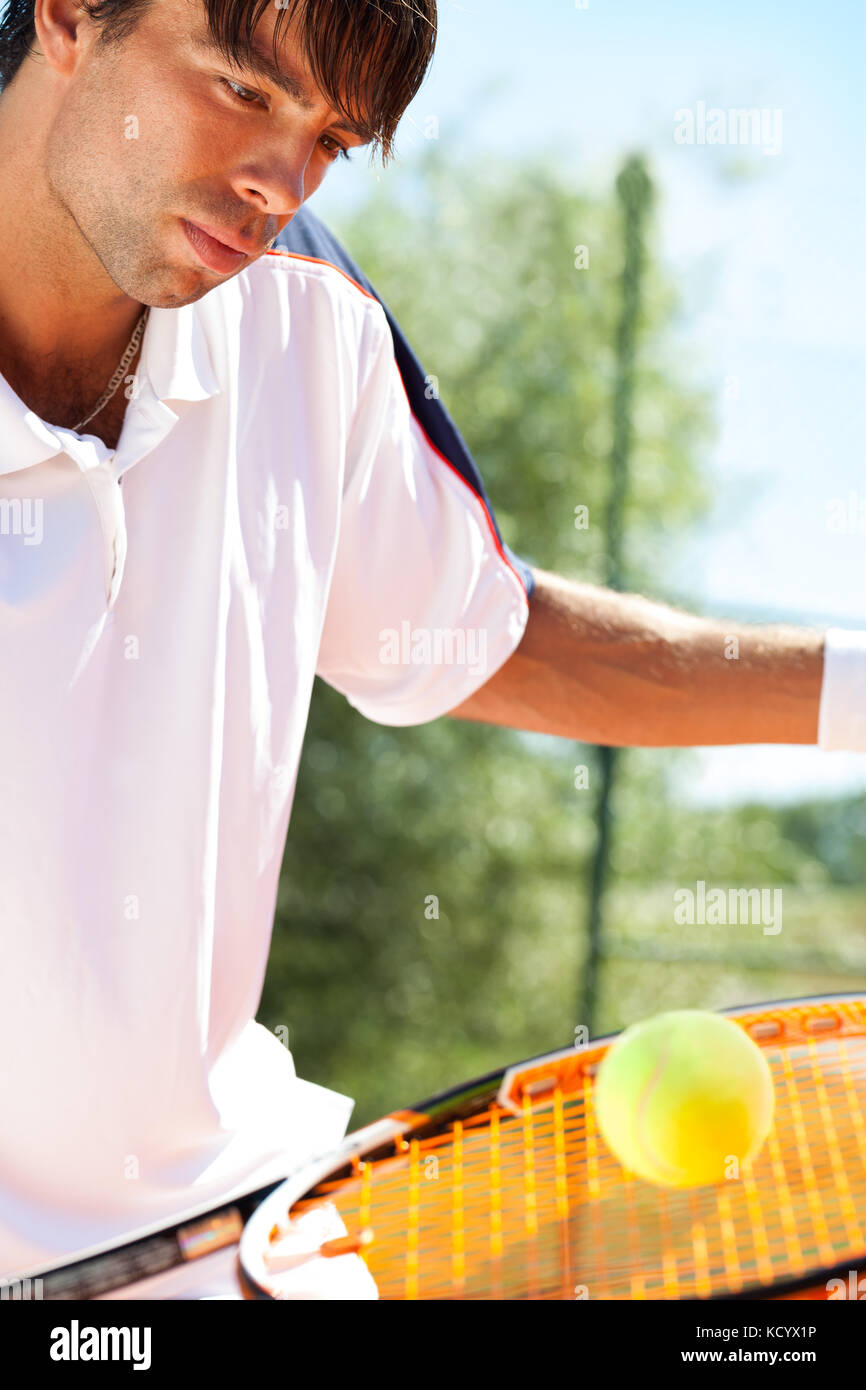 young tennis player hitting the ball with the racket Stock Photo - Alamy