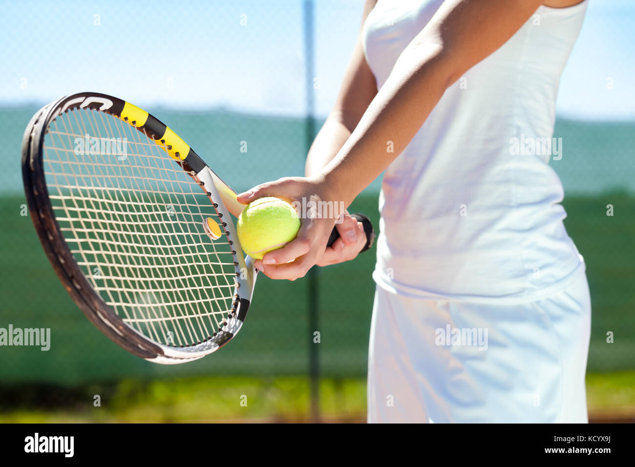 Player's hand with tennis ball and racket Stock Photo - Alamy