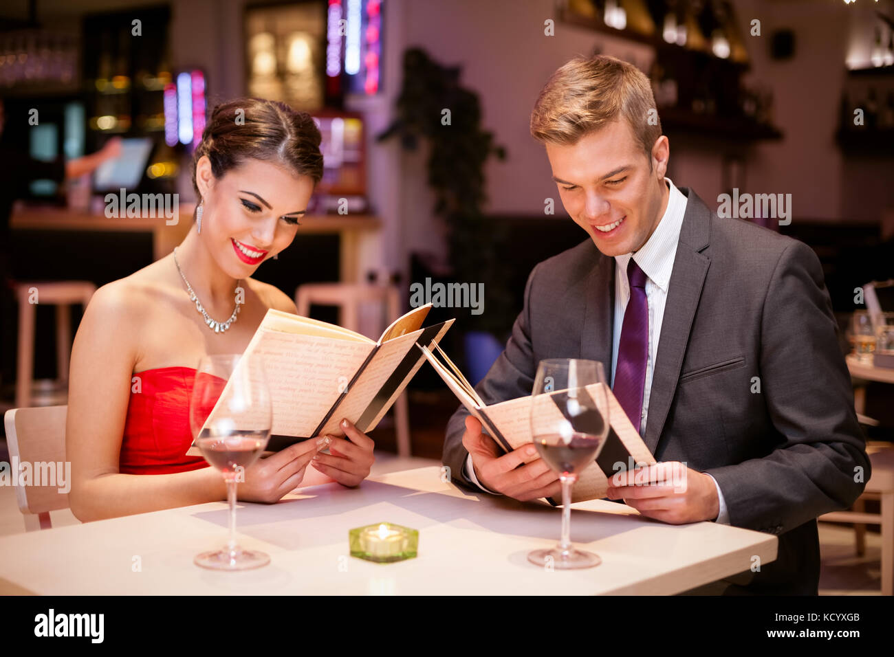 young couple dining in restaurant and reading menu Stock Photo - Alamy