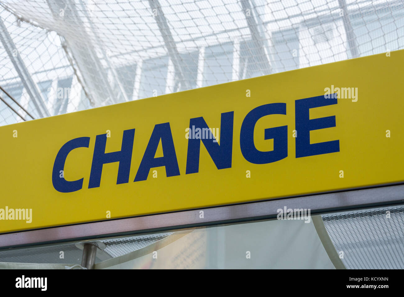 Blue and yellow change sign to change money close up Stock Photo - Alamy