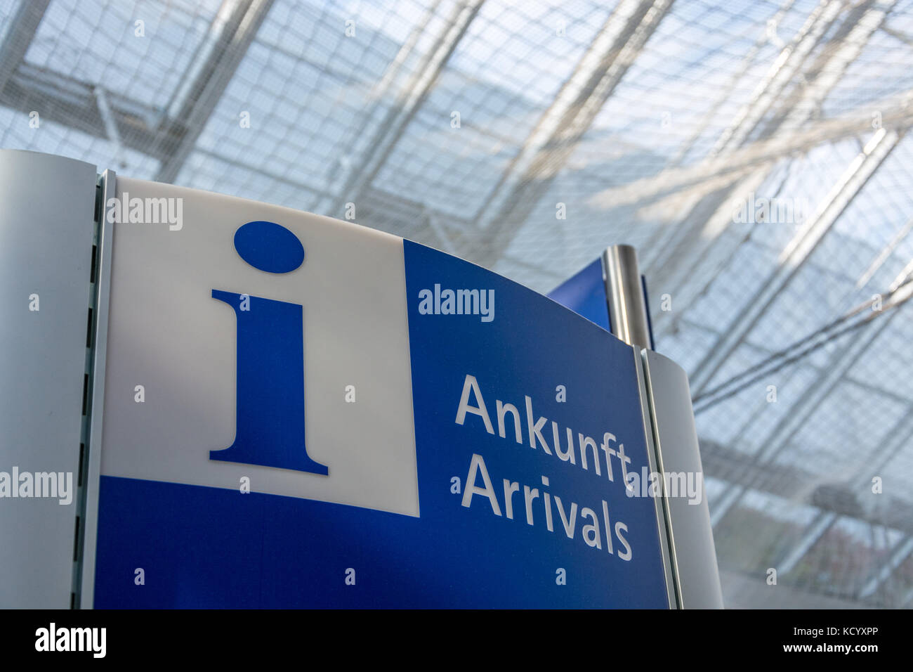 Blue info sign at the arrivals in English and German at the airport ...