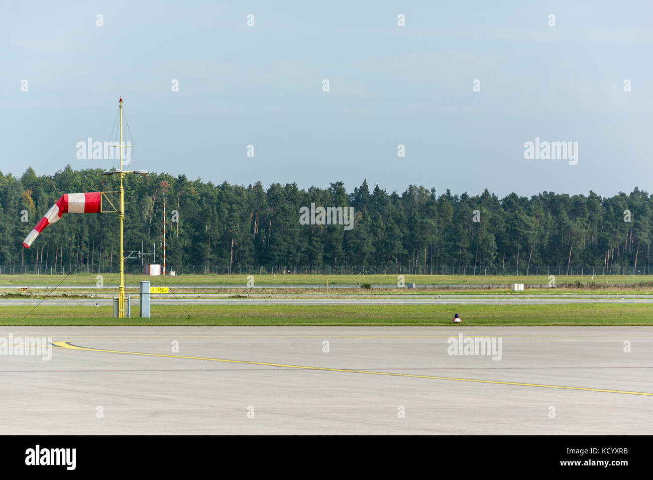 A red and white windsock at an airport runway Stock Photo - Alamy