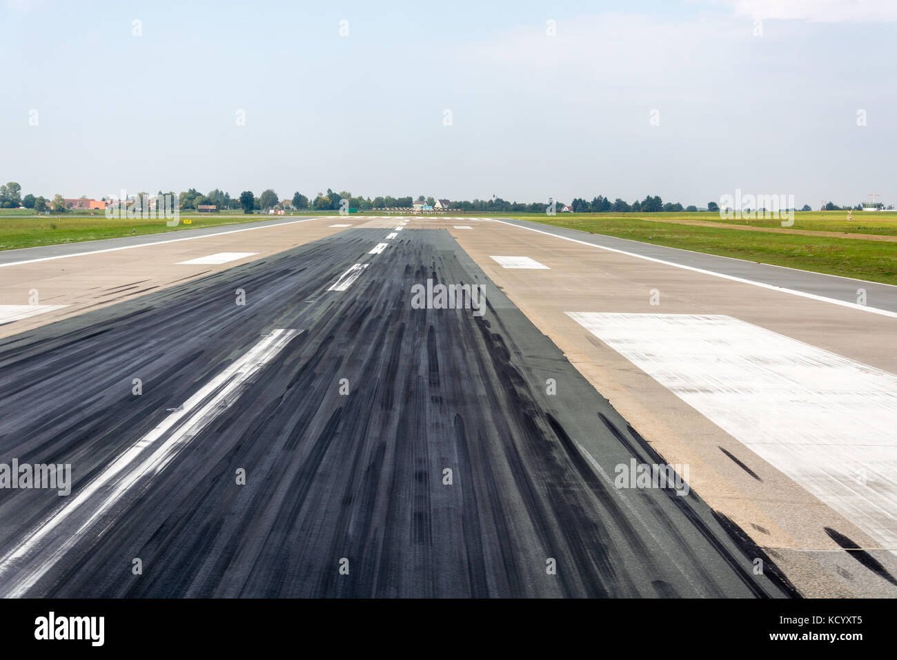 The runway at an airport with grass to the side Stock Photo - Alamy