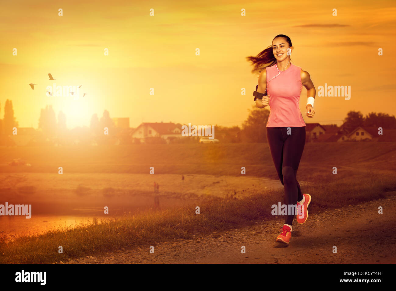 Young attractive woman jogging outdoor on sunset Stock Photo - Alamy