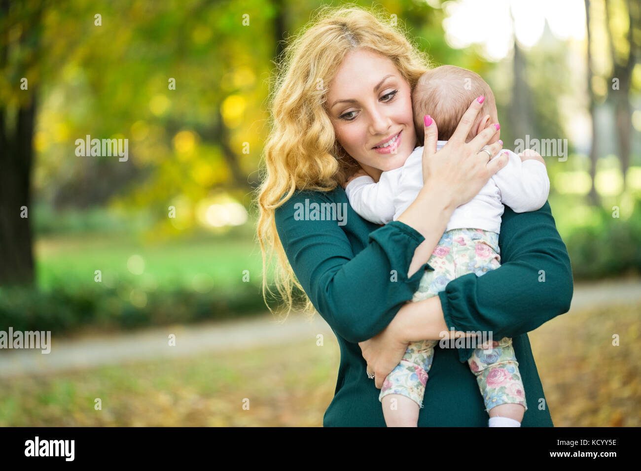 Careful mother hugging her little baby Stock Photo - Alamy