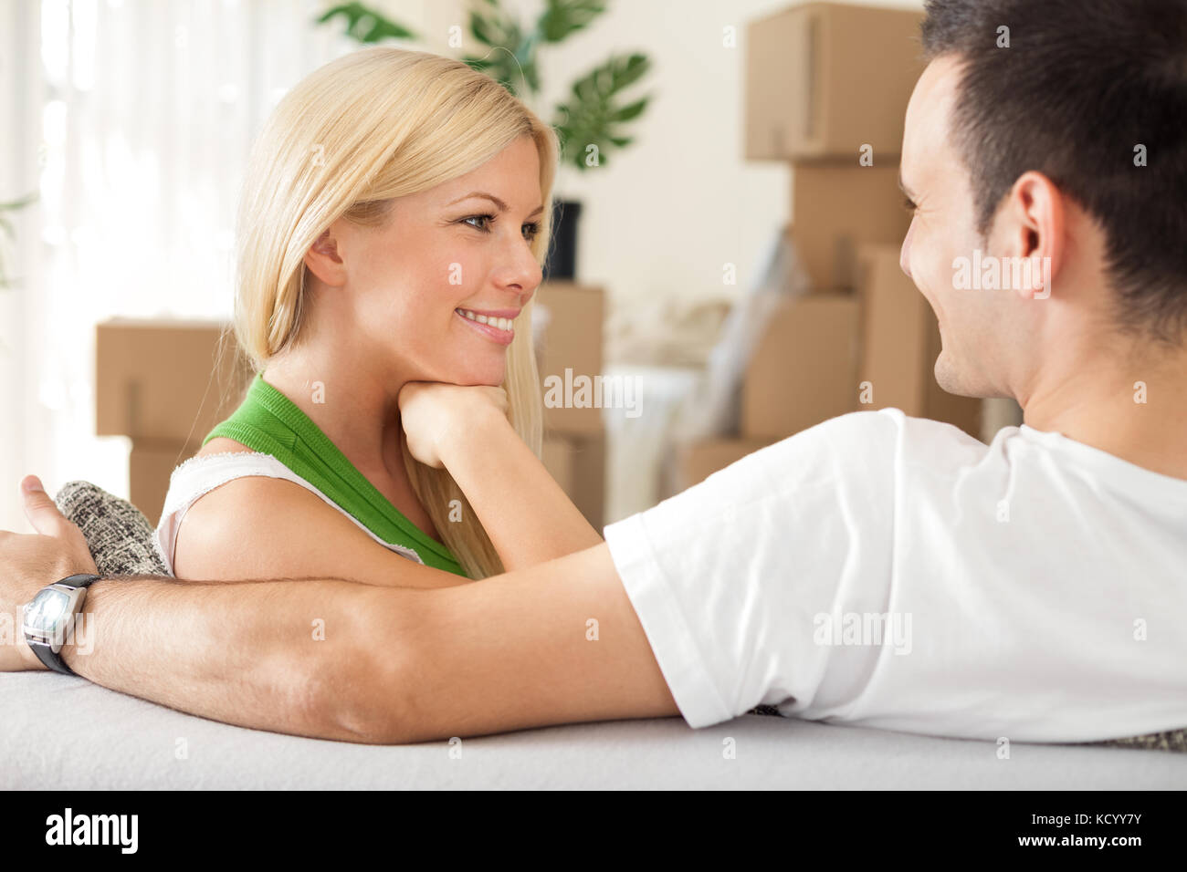 Young girl talking with boyfriend in new home Stock Photo - Alamy
