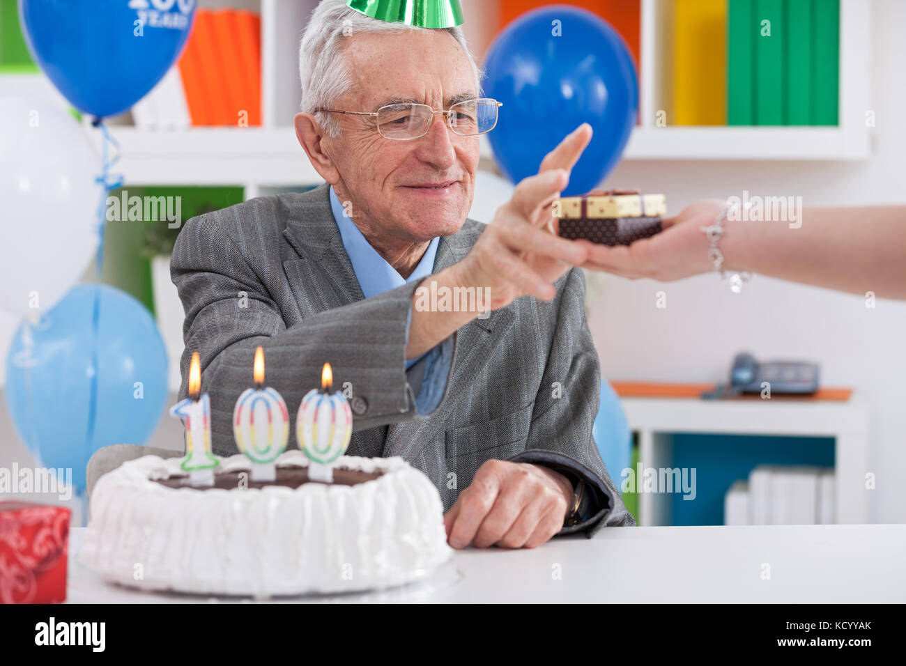 giving to grandfather a present for his birthday at home Stock Photo ...