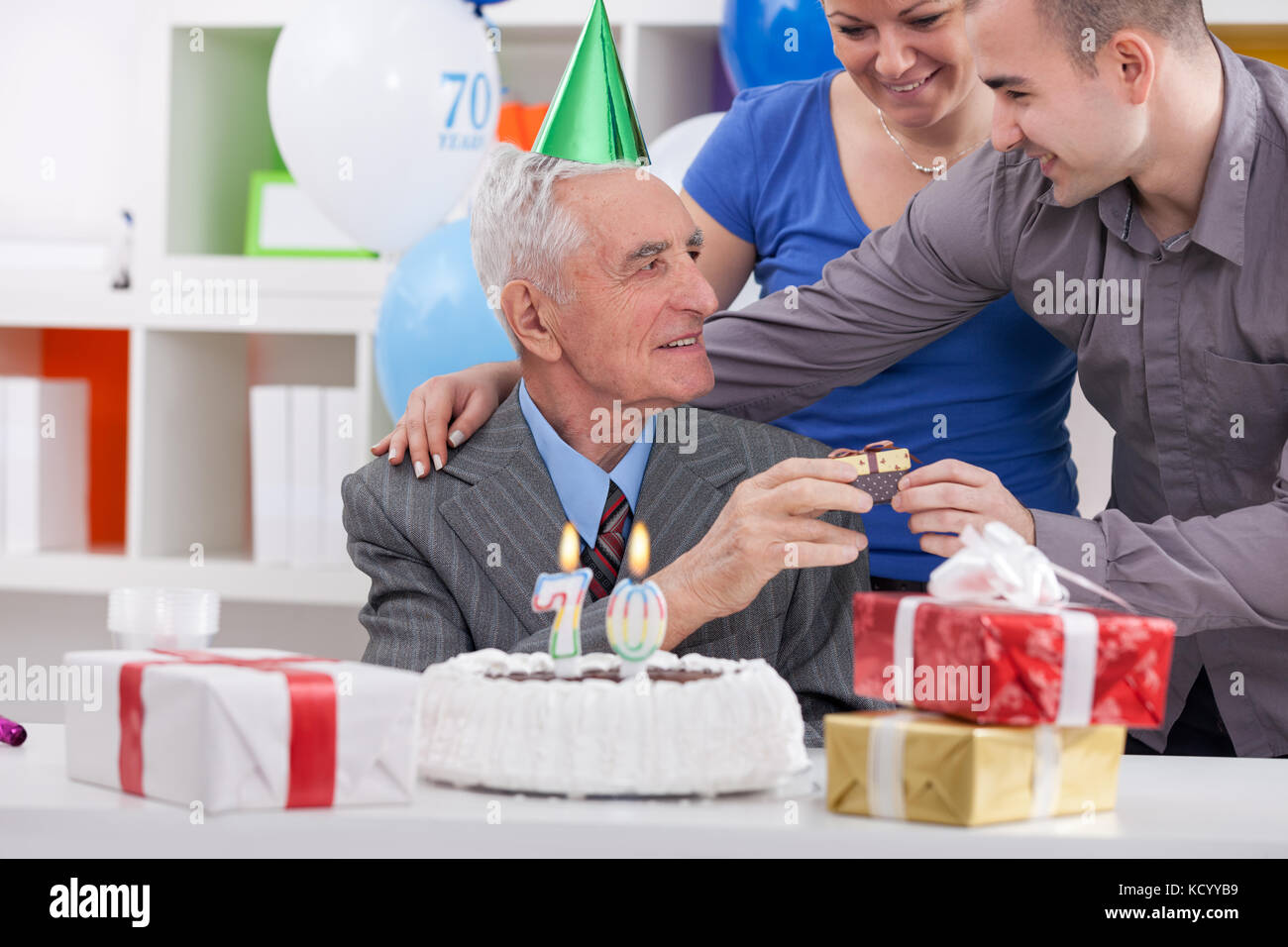 Family giving to father a present for his birthday Stock Photo - Alamy