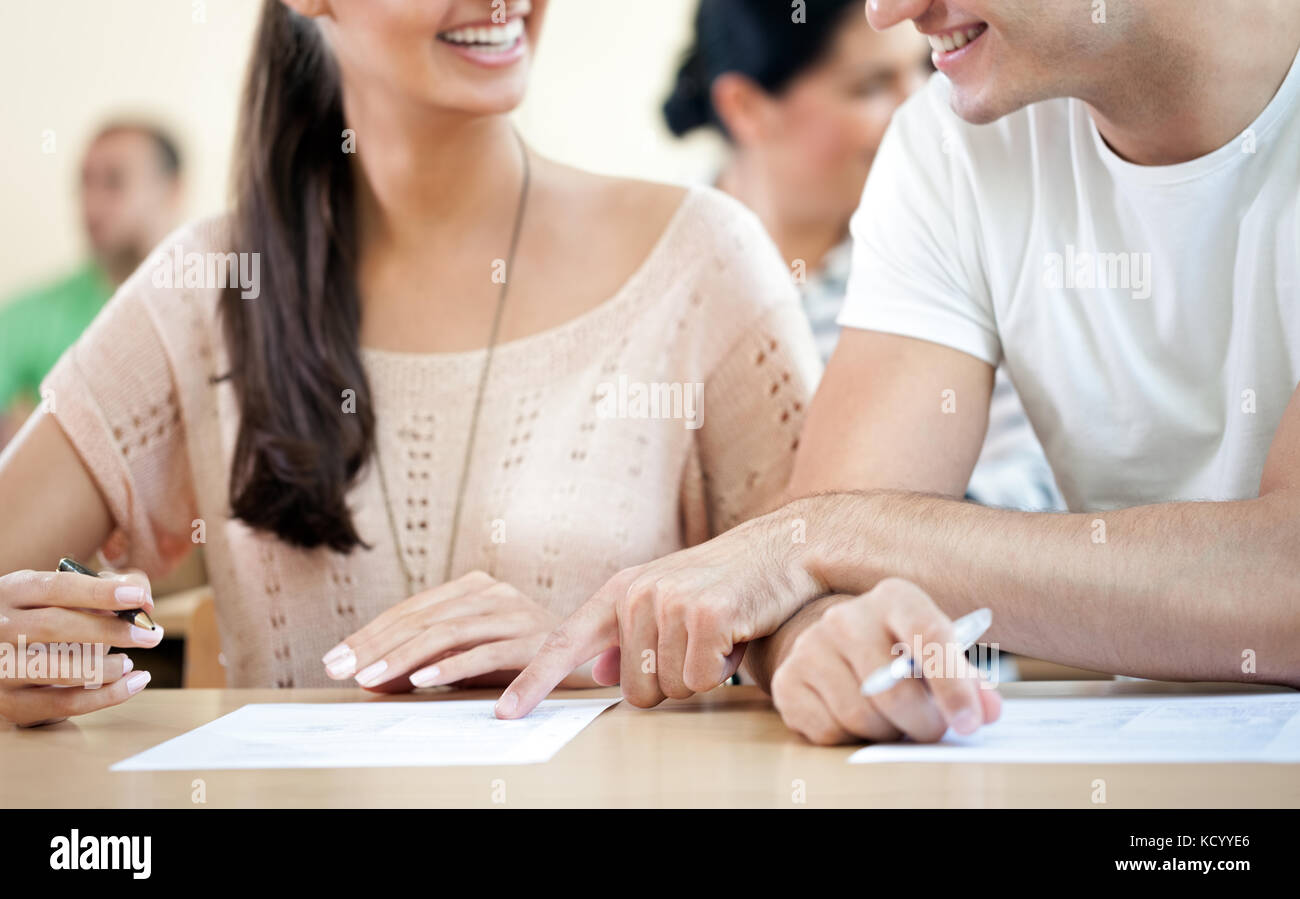 student assisting his female friends on class Stock Photo - Alamy