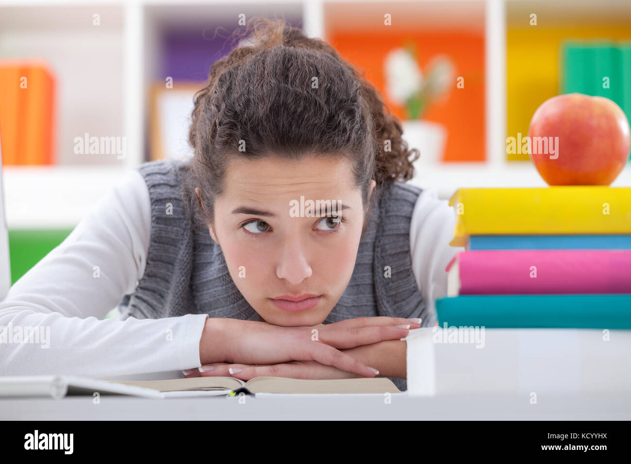 sad schoolgirl with learning difficulties with books Stock Photo - Alamy