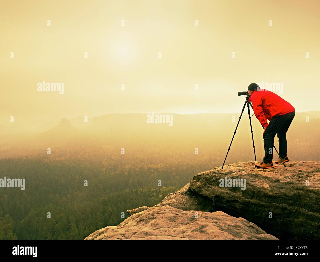 Professional photographer work on mountain peak. Nature photographer ...