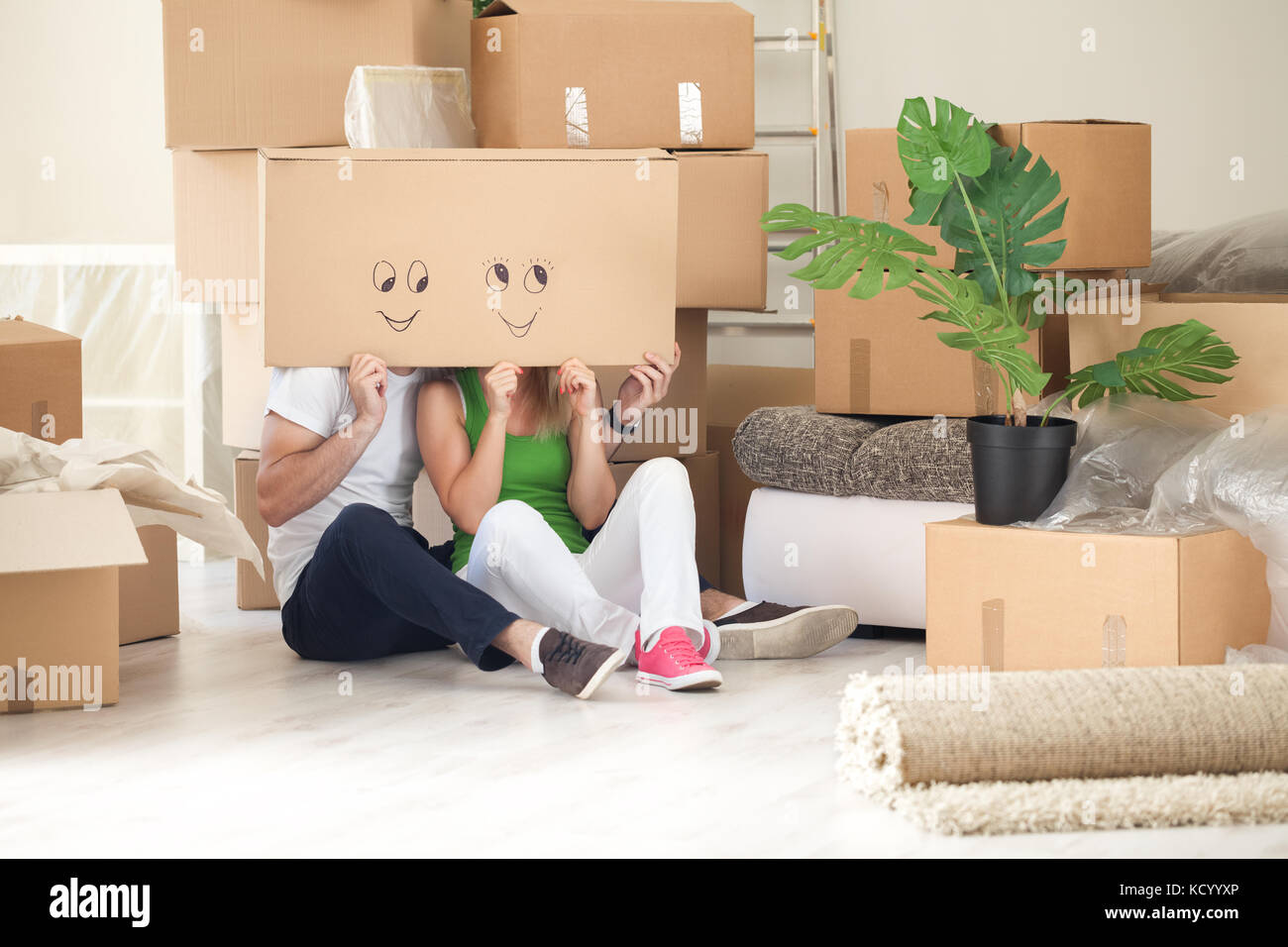 Happy couple in their new home having fun - moving concept Stock Photo ...