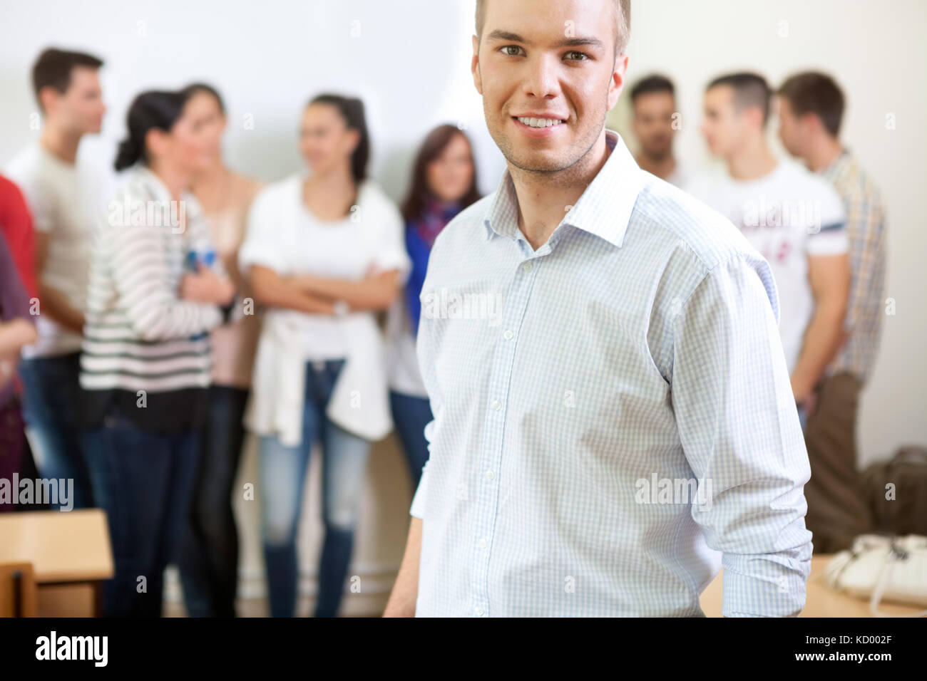 Smiling young student with colleagues Stock Photo - Alamy