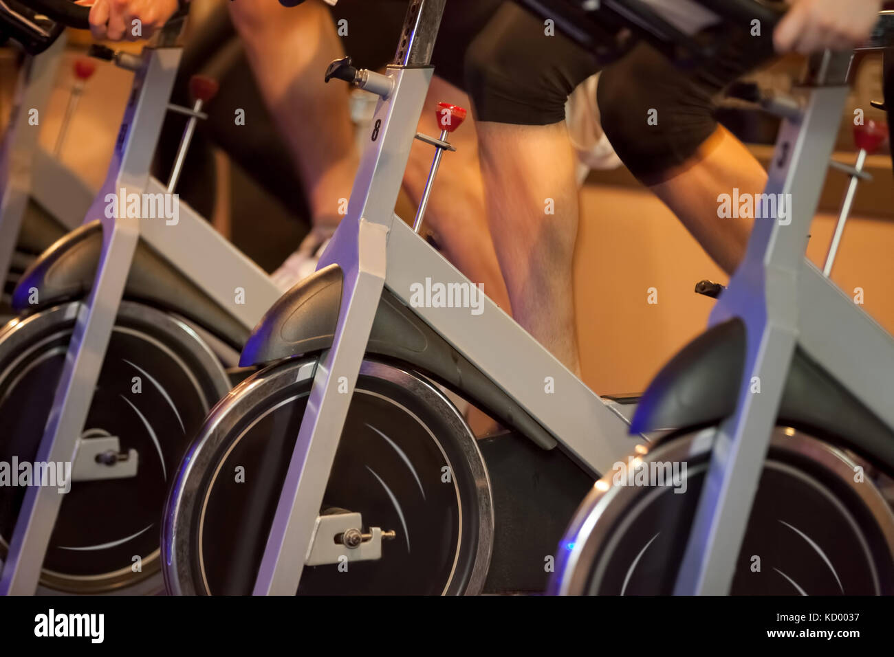 Group of four people spinning in the gym, exercising their legs doing ...