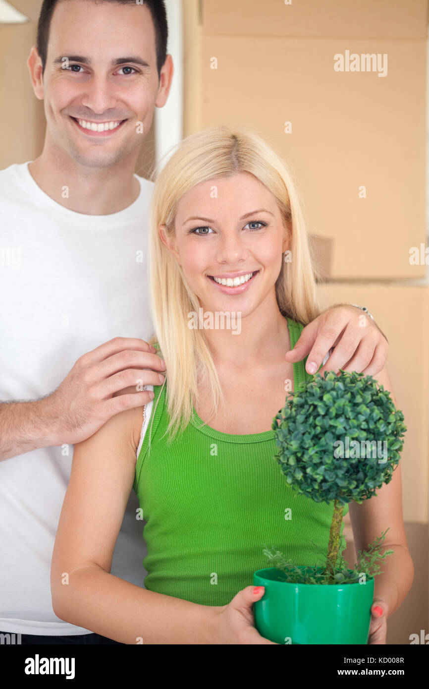 Young couple beginning to living together in new home Stock Photo - Alamy