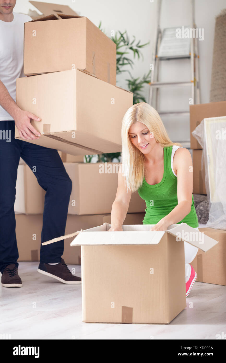 Couple unpacking cardboard boxes in a new home Stock Photo - Alamy
