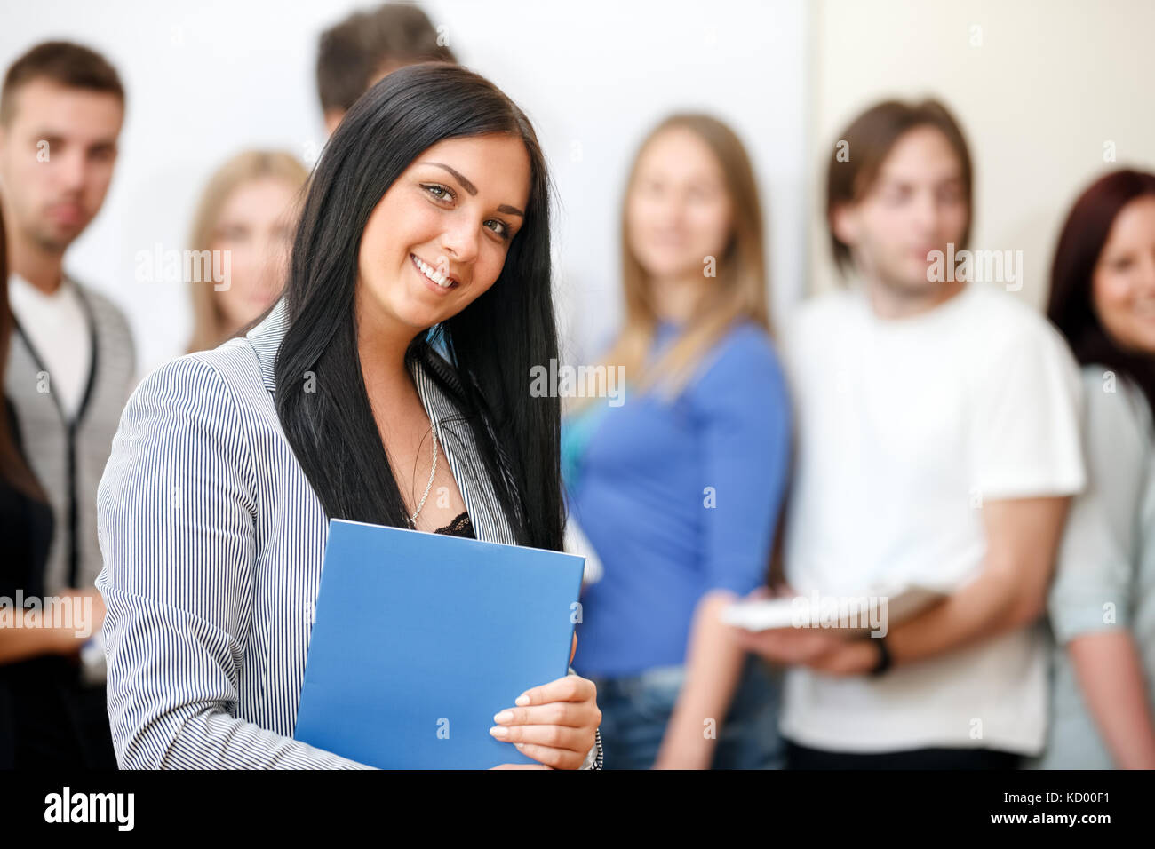 Happy female student holding notebook Stock Photo - Alamy