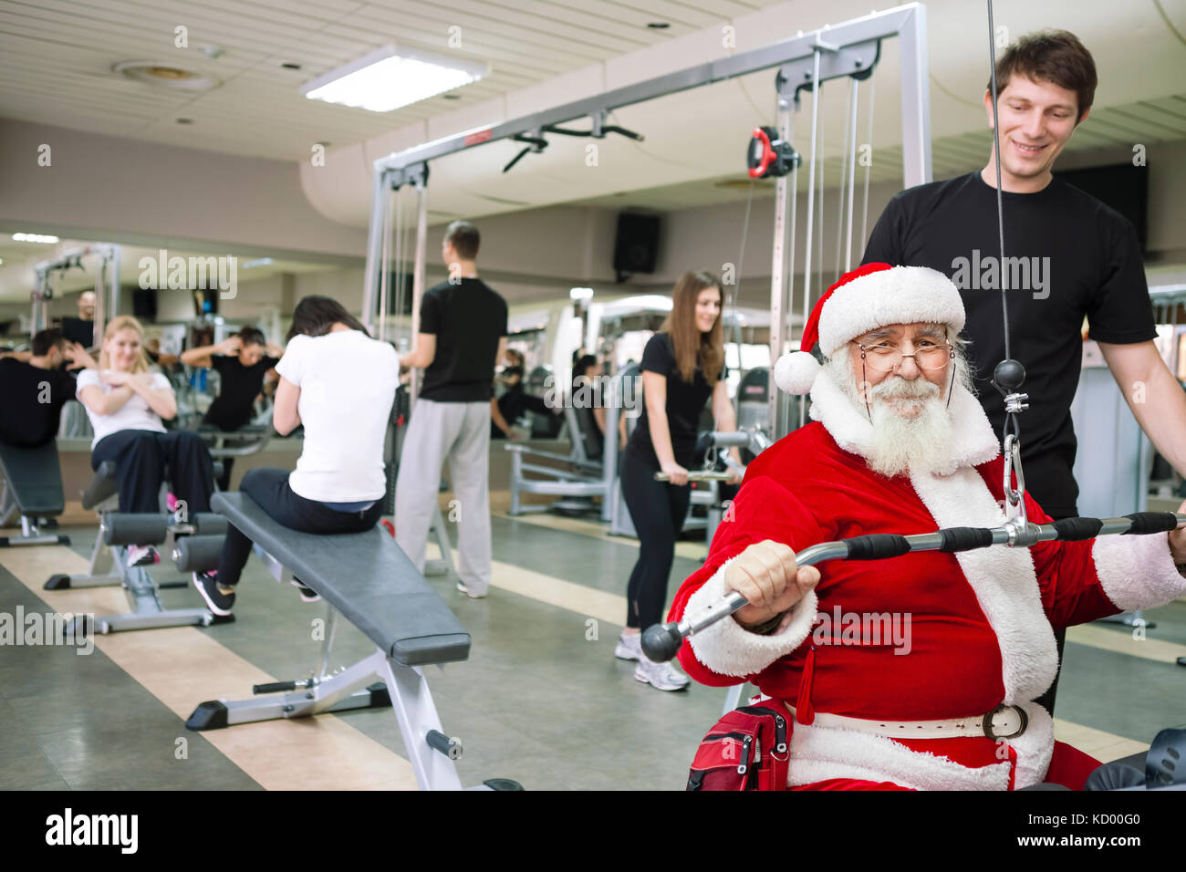 Santa Claus doing exercises at a gym Stock Photo - Alamy