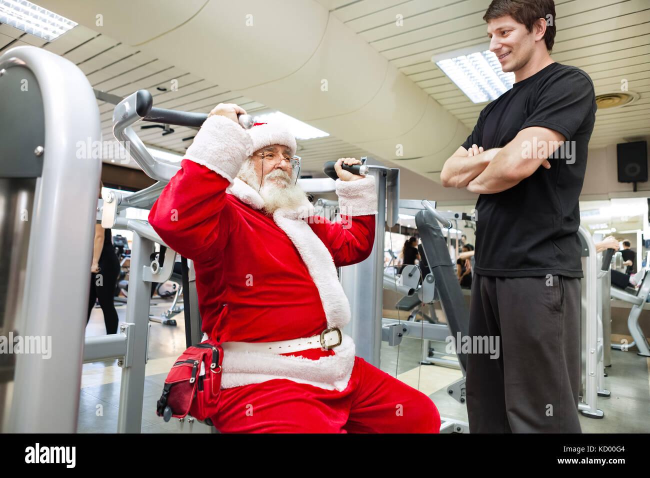Santa Claus exercise with personal trainer in the gym Stock Photo - Alamy