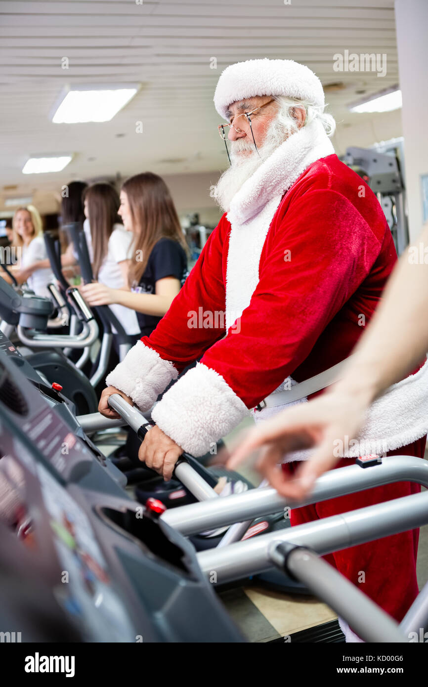Santa Claus workout on a treadmill at gym Stock Photo - Alamy