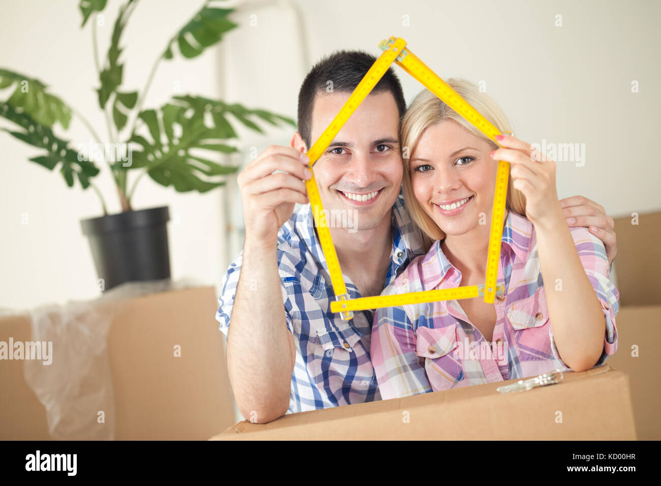 Happy smiling couple moving into first new home Stock Photo - Alamy