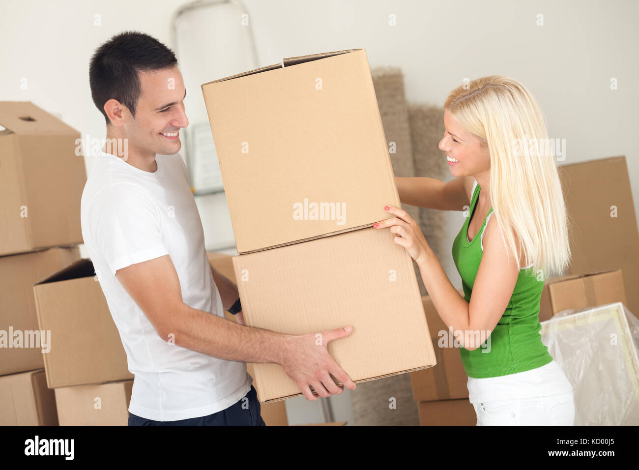 Couple carrying moving boxes Stock Photo - Alamy