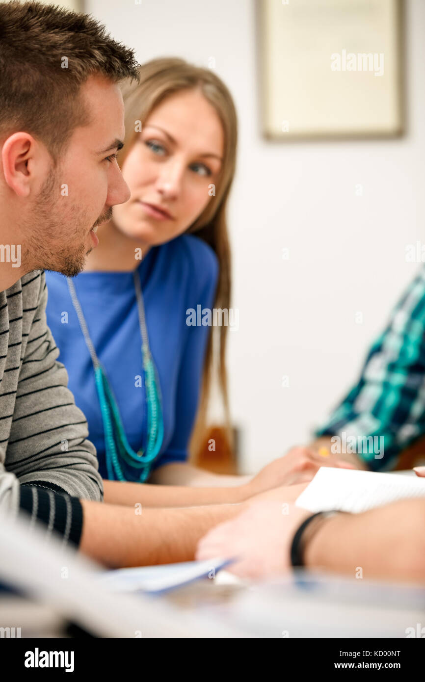 Young student talking with friends during class Stock Photo - Alamy