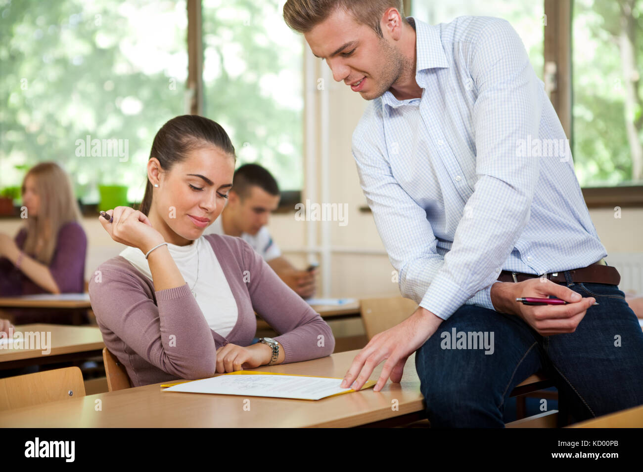 Teacher instructing female student Stock Photo - Alamy