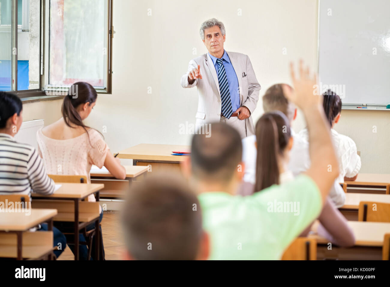 Student with hand up in class, classroom activities Stock Photo - Alamy