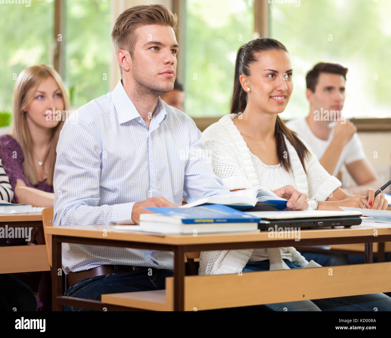 Group of students in class looking very happy Stock Photo - Alamy