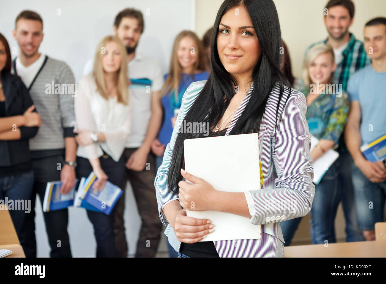 Beautiful success student with class in background Stock Photo - Alamy