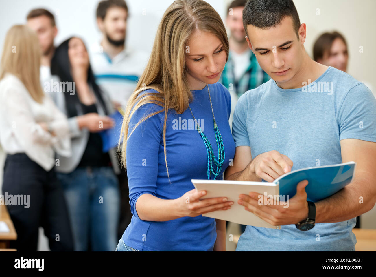 two college students reading book Stock Photo - Alamy