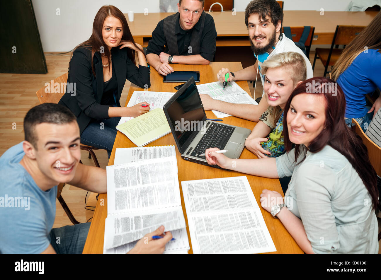 Happy friends studying together in classroom Stock Photo - Alamy