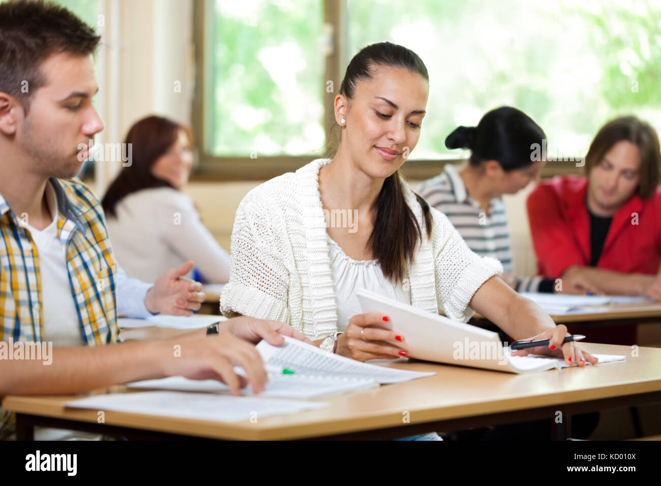 Young students in classroom studying together Stock Photo - Alamy