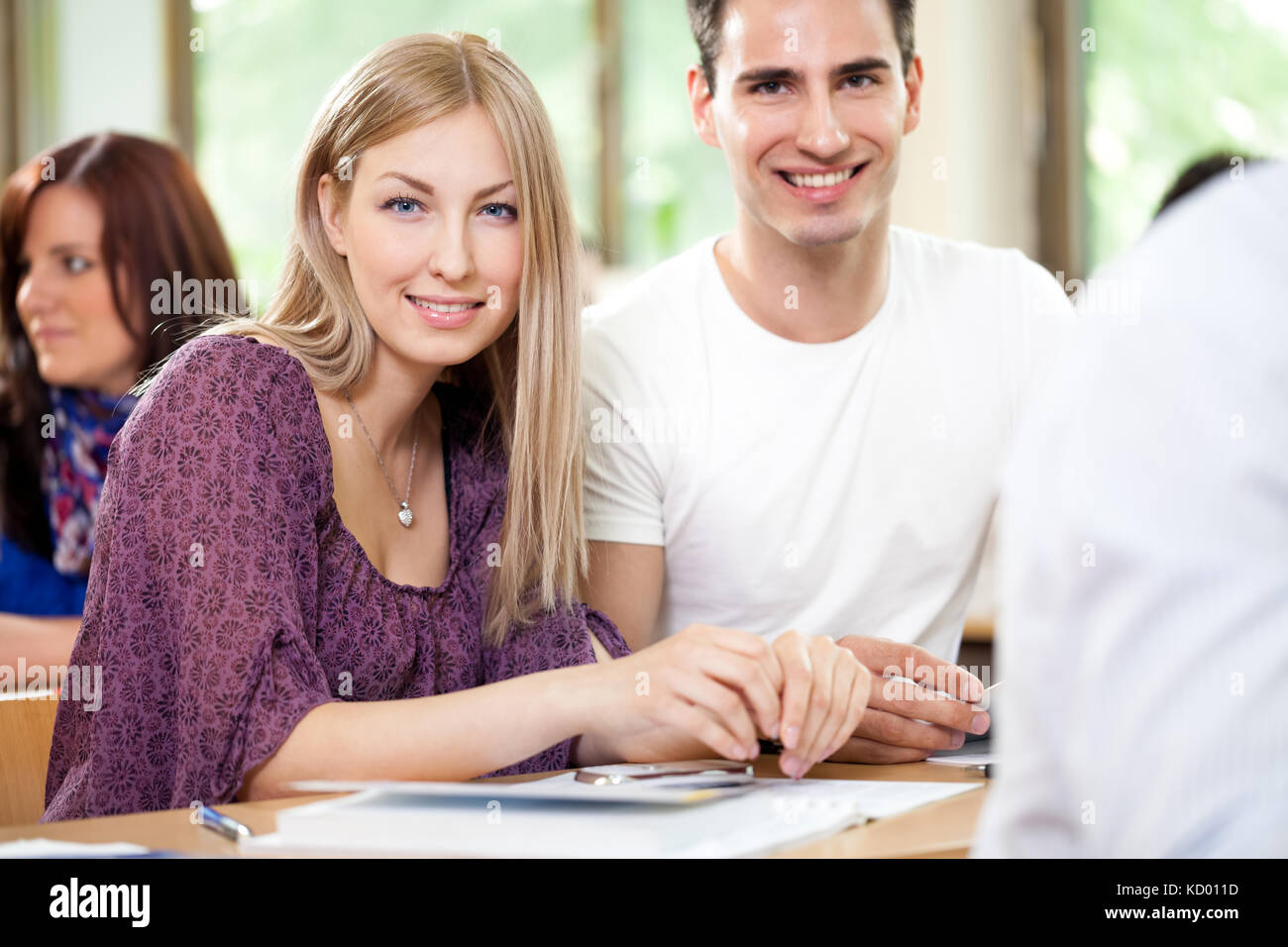Smiling student couple at classroom Stock Photo - Alamy
