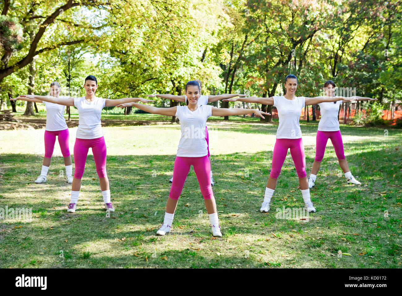 Group of six women doing fitness and lifting their arms Stock Photo - Alamy