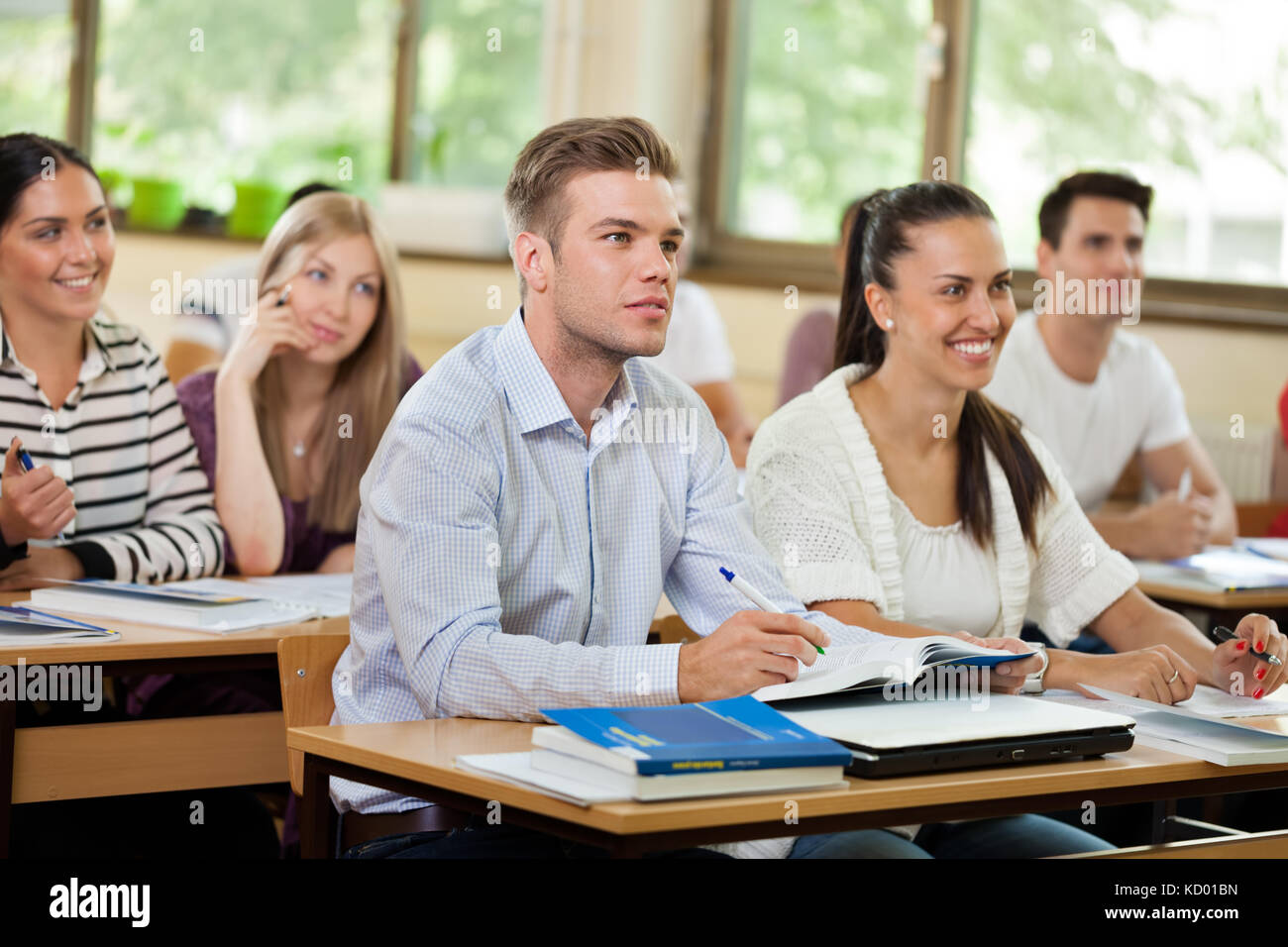 Group of young students in classroom listening a lecturer Stock Photo ...
