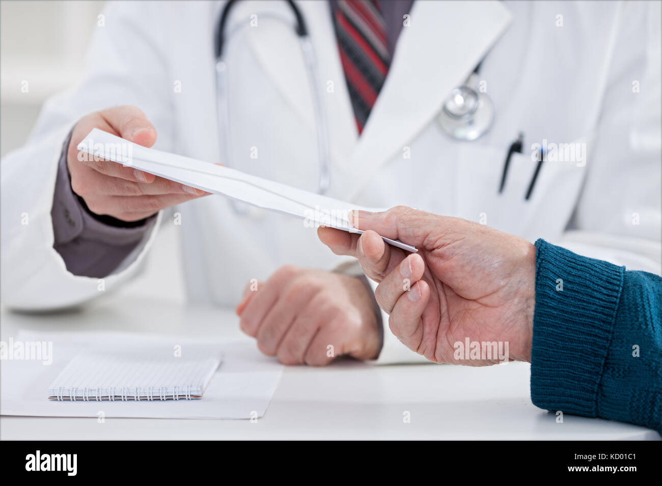 patient bribing doctor, giving money in envelope Stock Photo - Alamy