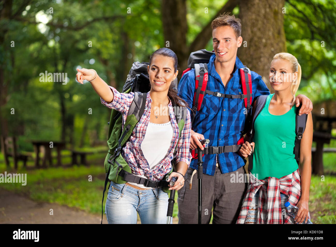 Hiking friends pointing and walking on path Stock Photo - Alamy