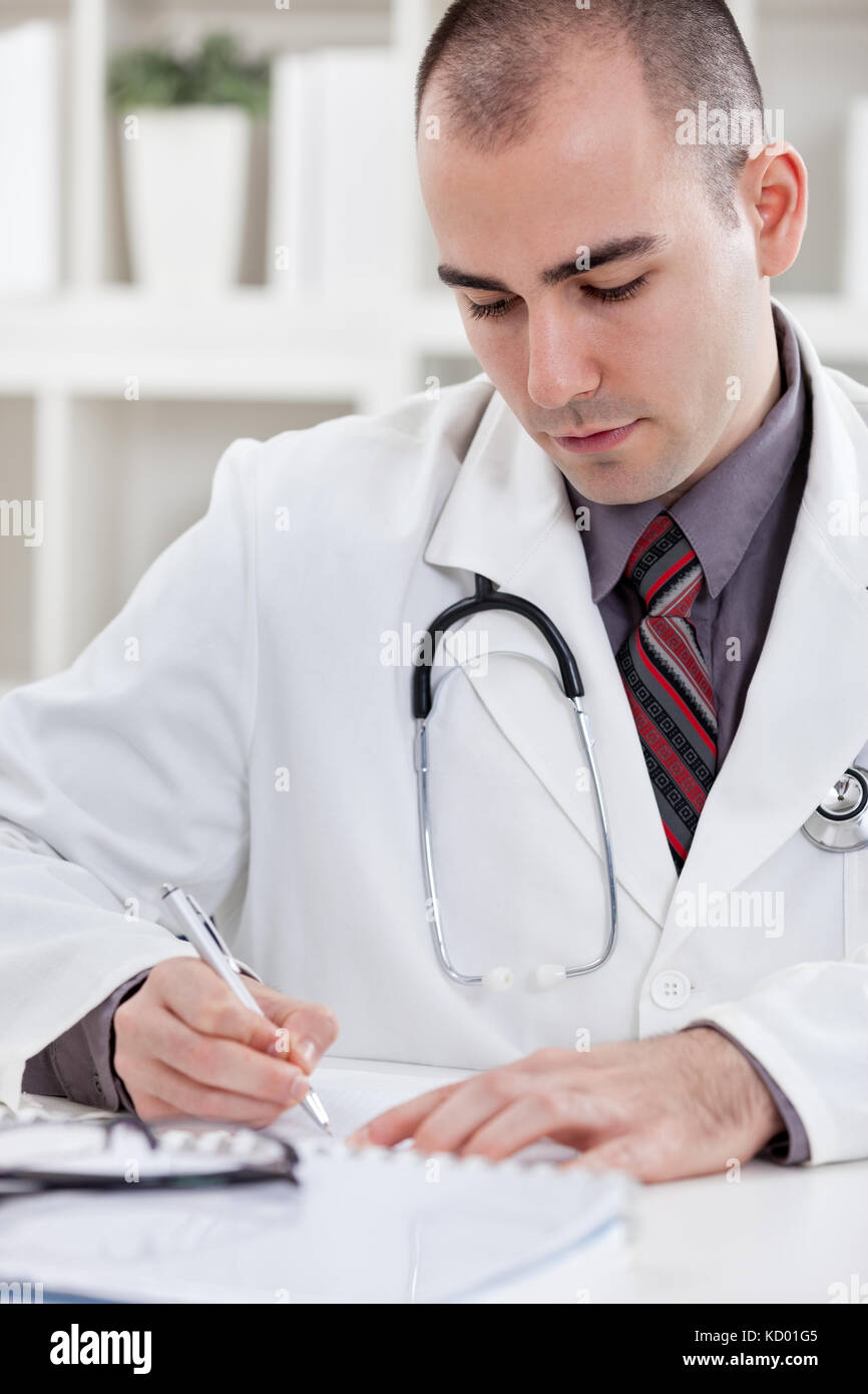Doctor writing prescription on patient hi-res stock photography and ...