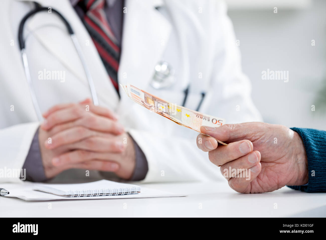 patient bribing doctor, giving money Stock Photo - Alamy