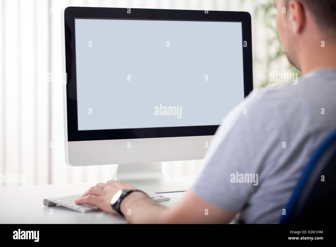 Man in front of computer screen Stock Photo - Alamy
