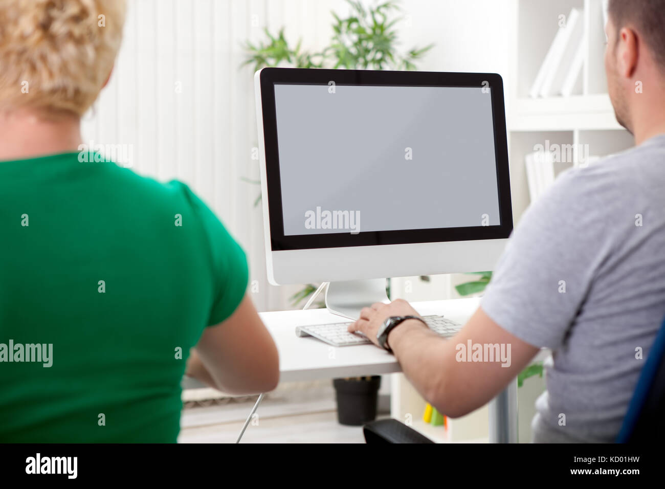 Two colleagues at work in front of computer screen Stock Photo - Alamy