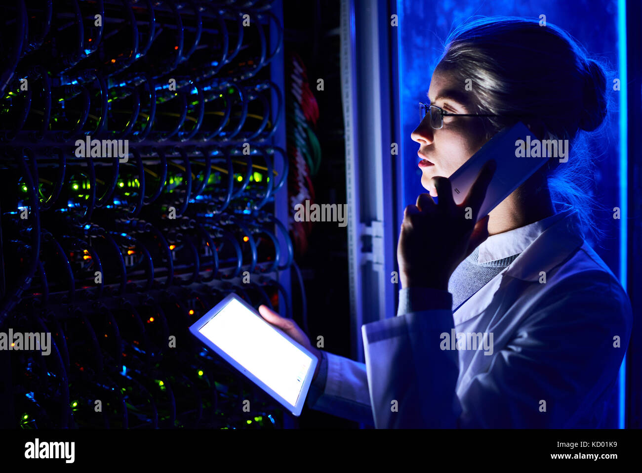 Side view portrait of beautiful female scientist working with ...