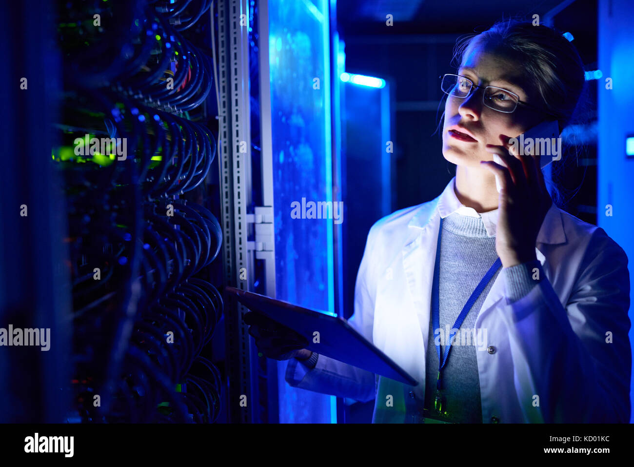 Portrait of beautiful female scientist working with supercomputer in ...