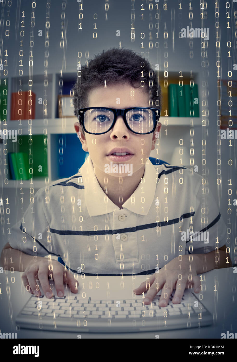 concentrated little boy typing on keyboard and looking at camera like ...